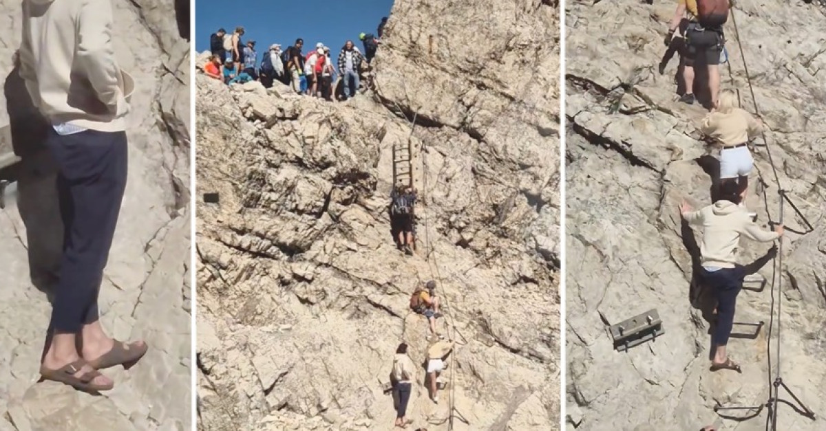 Si arrampica sulle scalette della ferrata con i sandali fra decine di ...